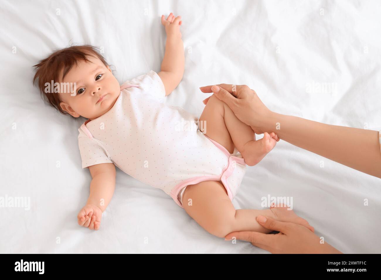Cute little baby getting massage on bed, top view Stock Photo - Alamy