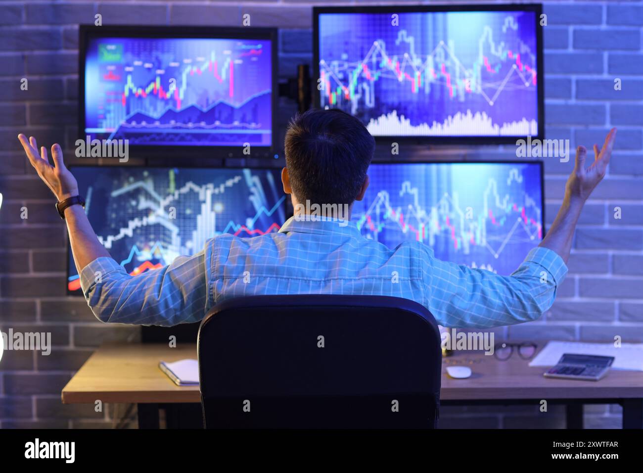 Male trader working in office at night, back view Stock Photo - Alamy