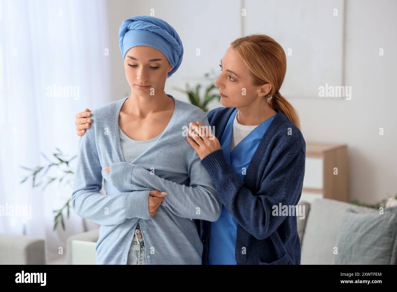 Sad young woman after chemotherapy with nurse at home Stock Photo - Alamy