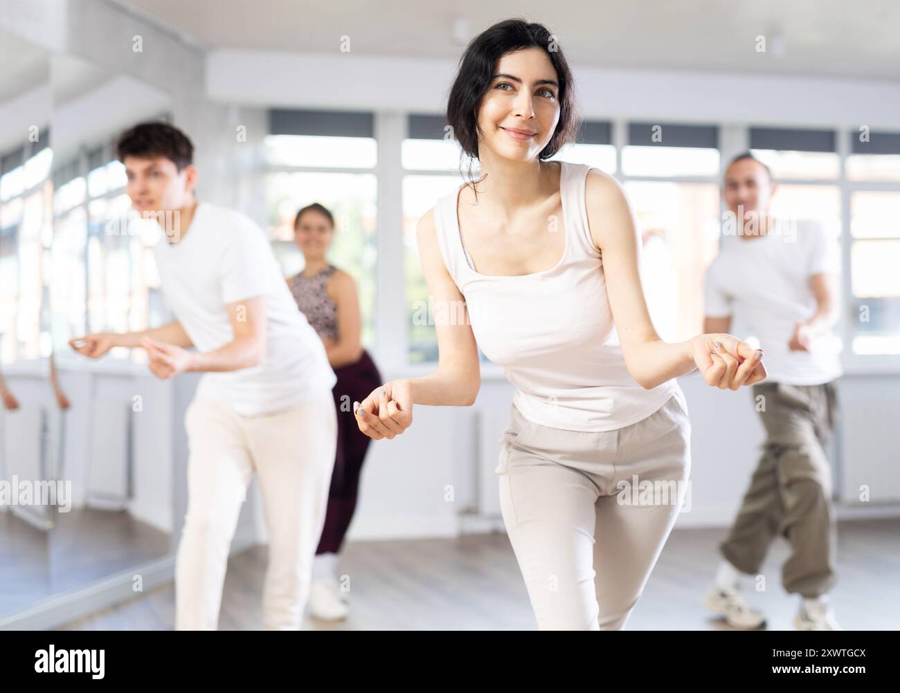 Girl enjoys active dancing, learns new movements, moves synchronously ...