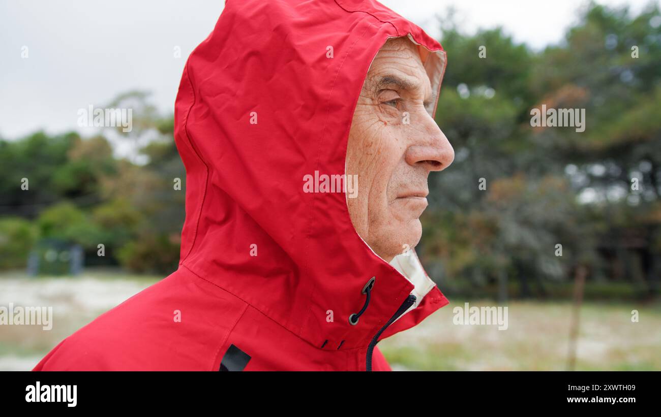 Man Taking Off The Raincoat Hood Stock Photo - Alamy