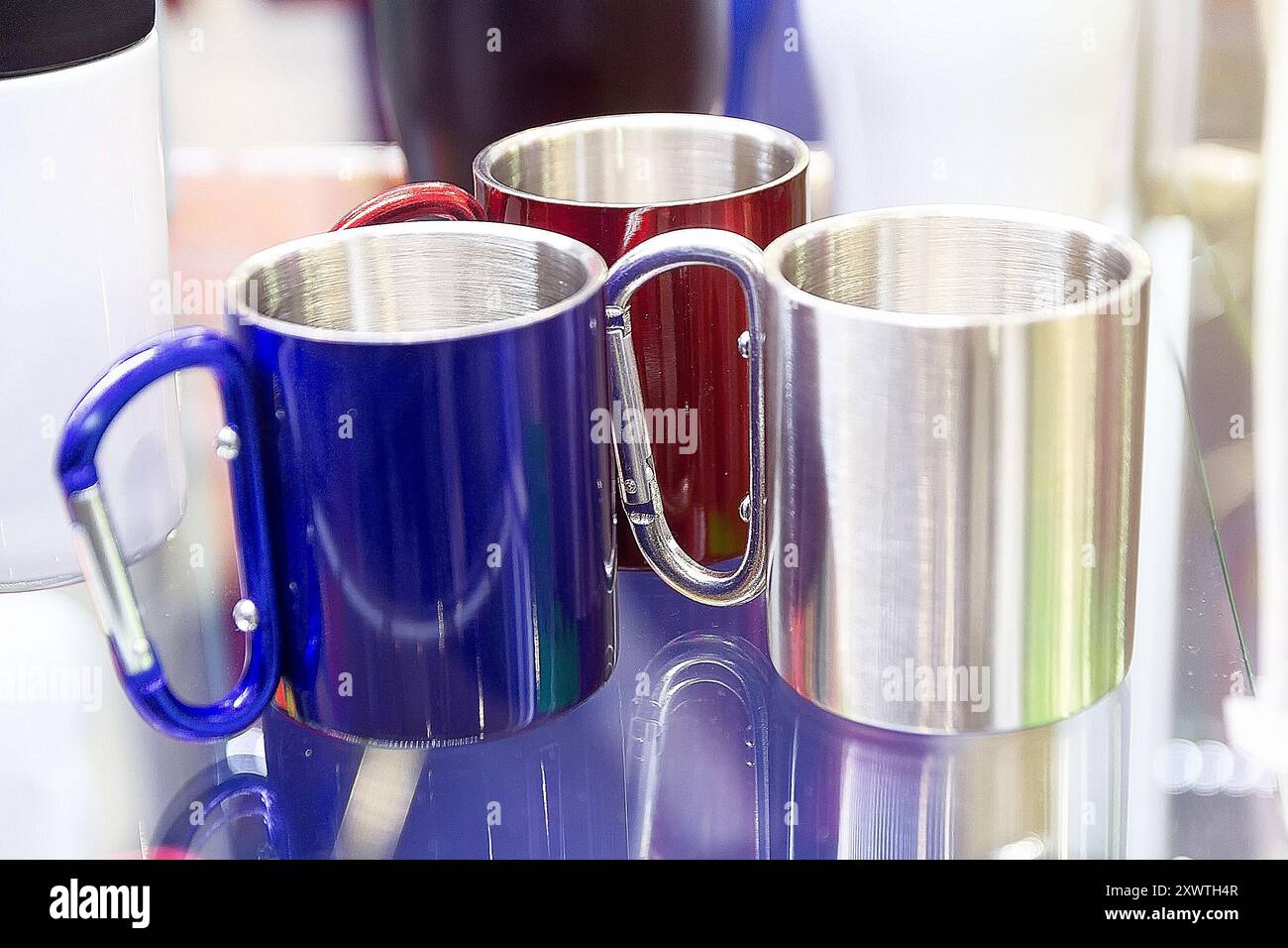 Metal tourist mugs on the store counter Stock Photo - Alamy