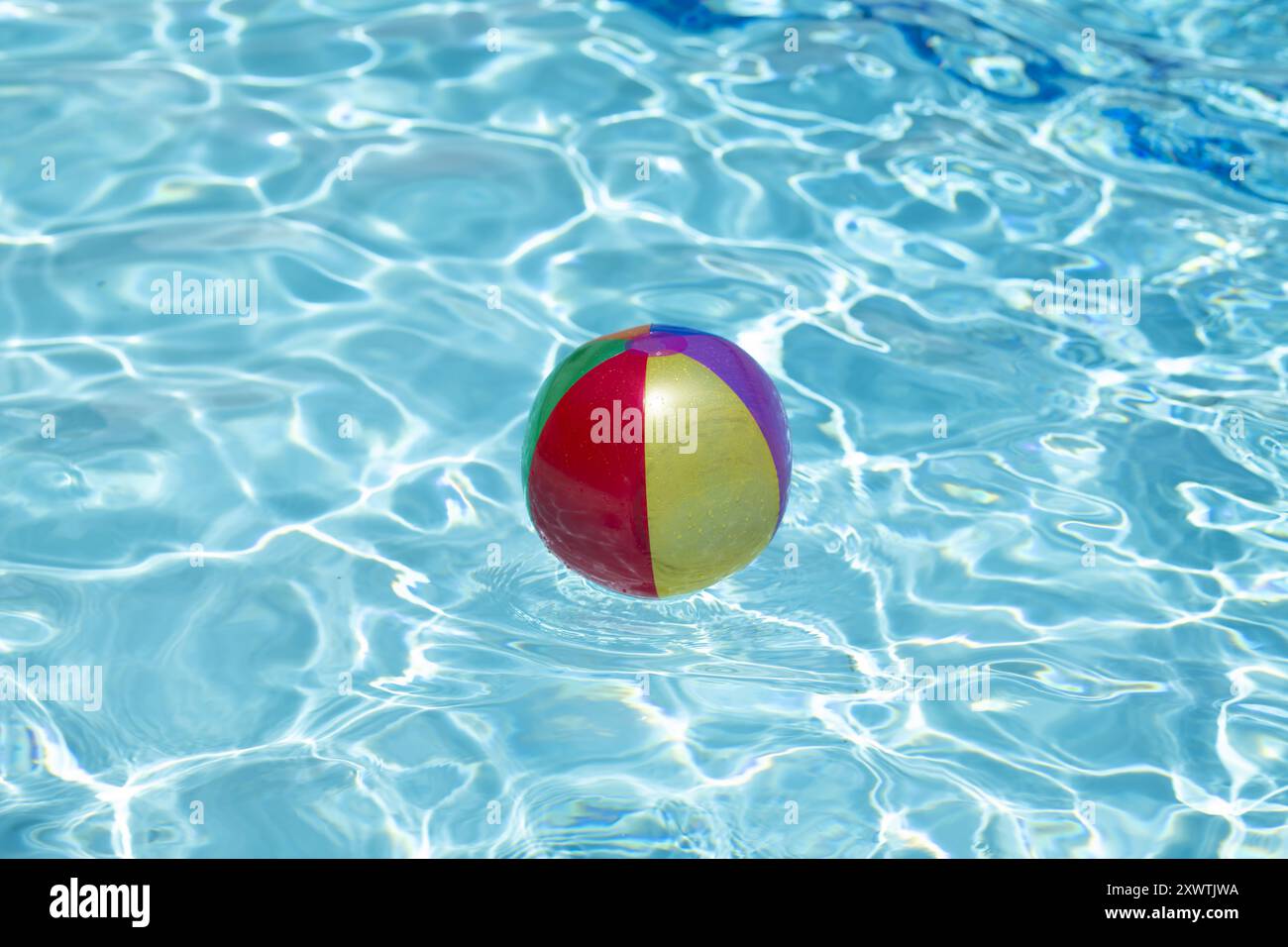 Summer swimming pool. Beach ball in swimming pool. Summer vacation ...