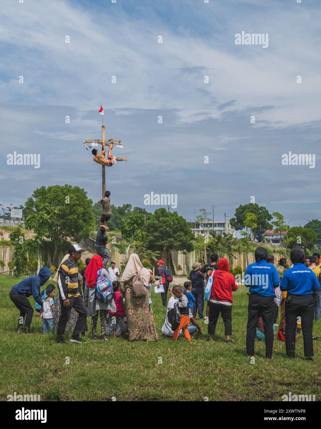 Balikpapan, Indonesia - August 18th, 2024. The male climber is cheered ...
