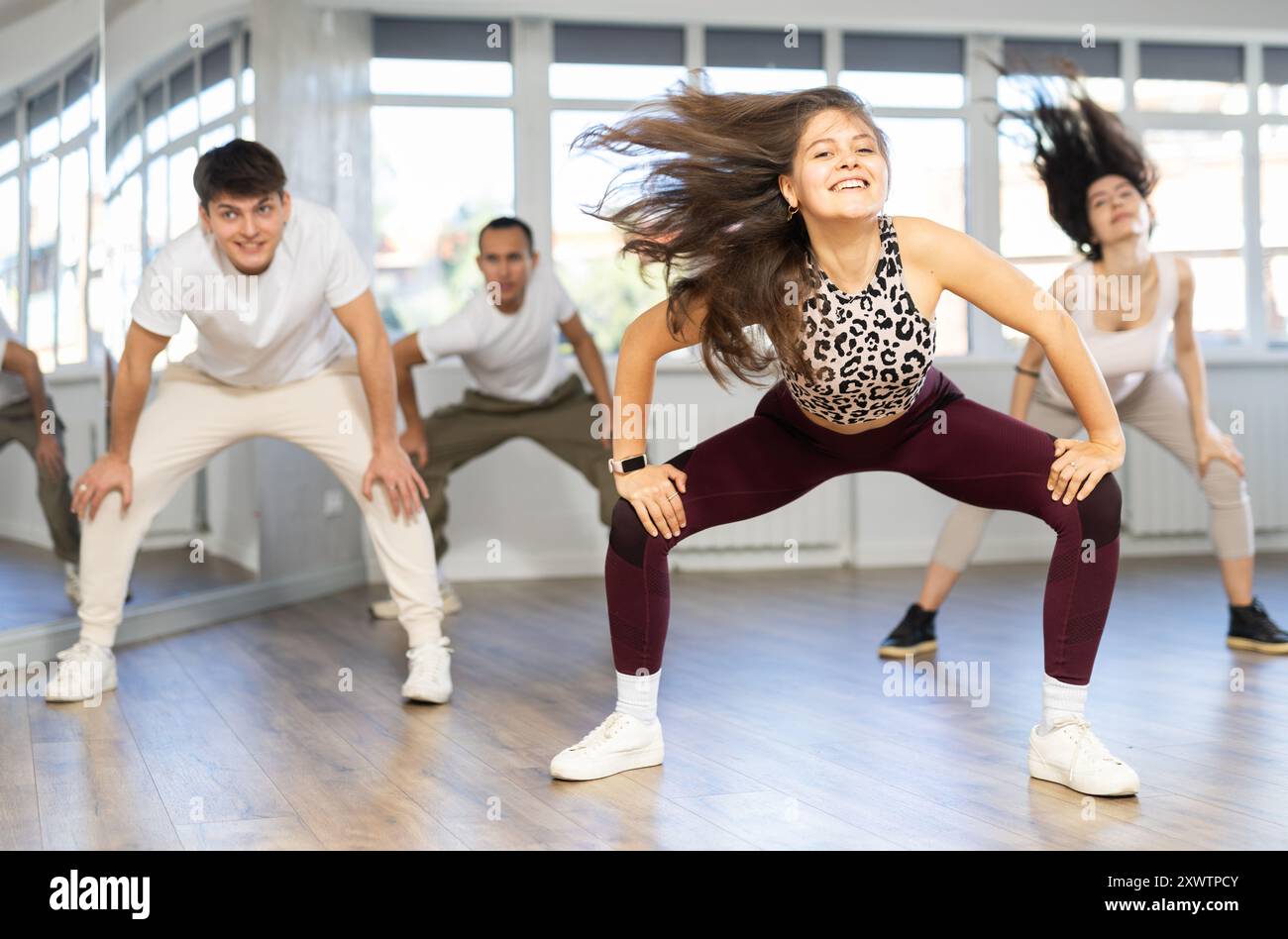 Group of people, girls and guys in sportive casual style clothes ...