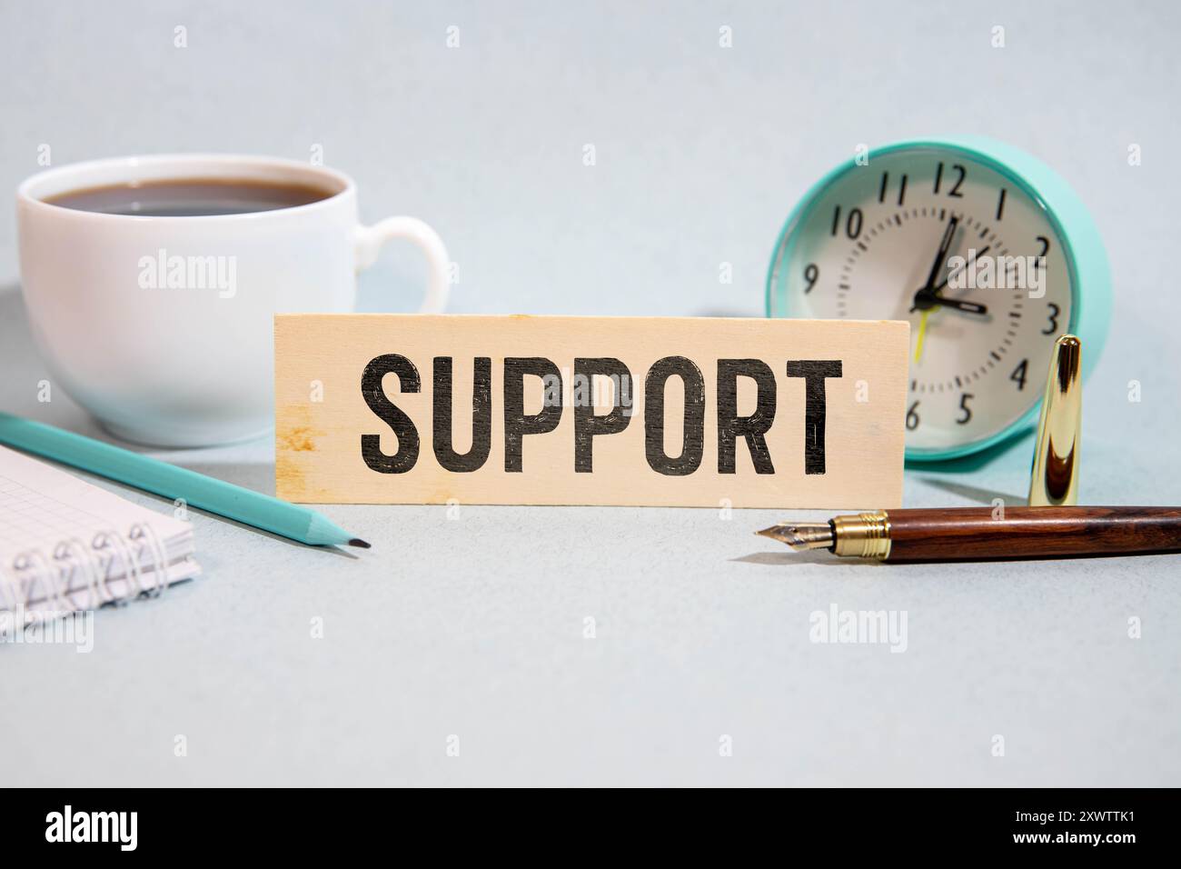 Support word written on wood block. Support text on cement table for ...