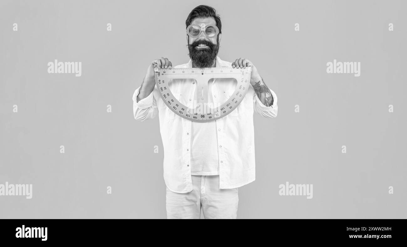 glad man hold geometry protractor on background. photo of man hold ...