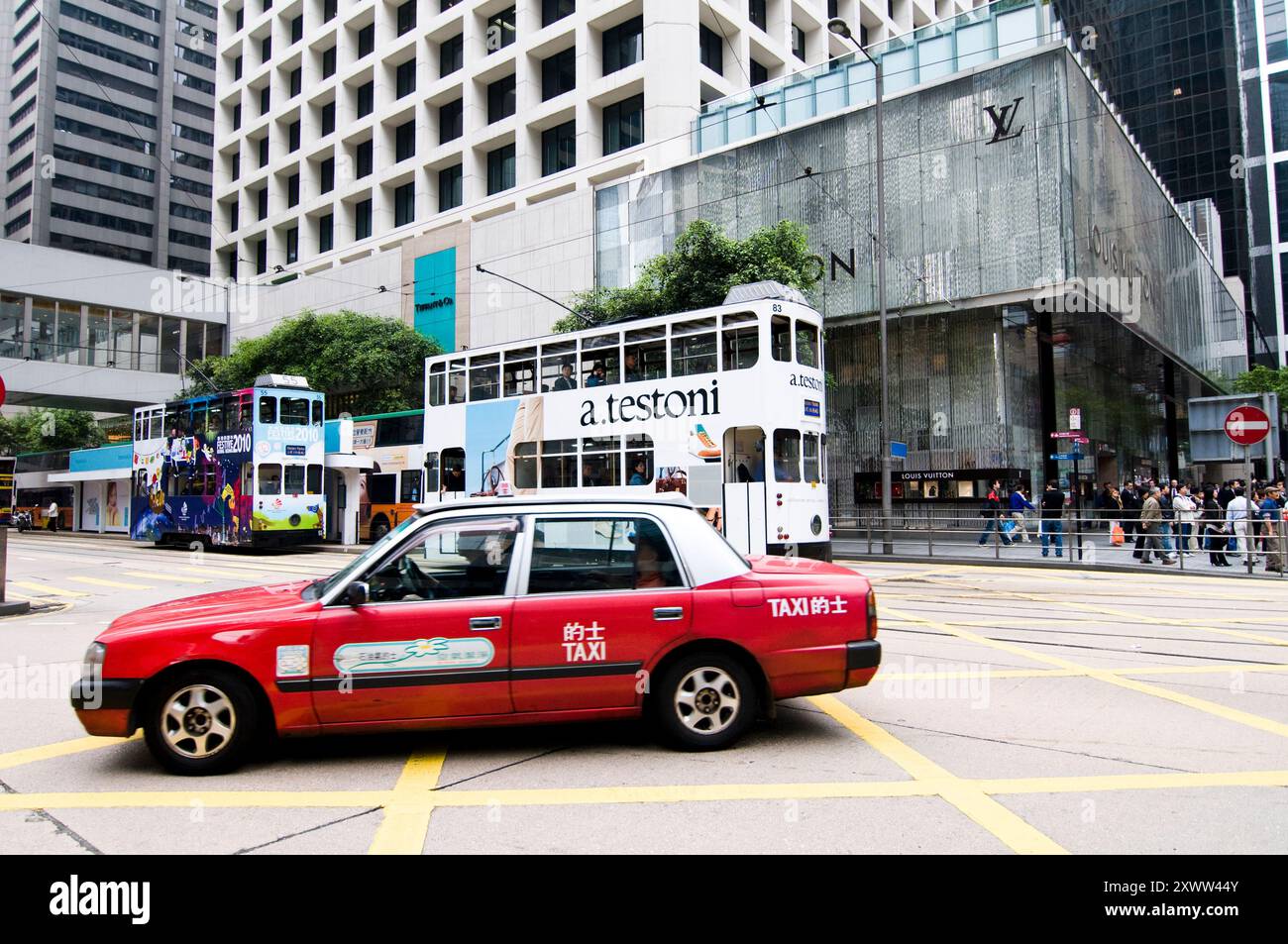 Toyota Comfort taxi and public trams in Hong Kong's Central district ...