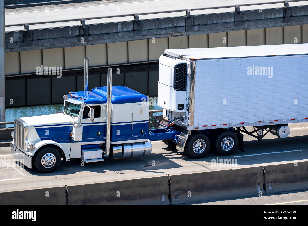 Classic blue and white big rig semi truck tractor with extended cab for ...