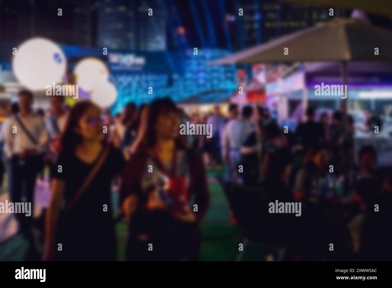 Blurry image of a crowd of people in Hong Kong, China at night, with ...