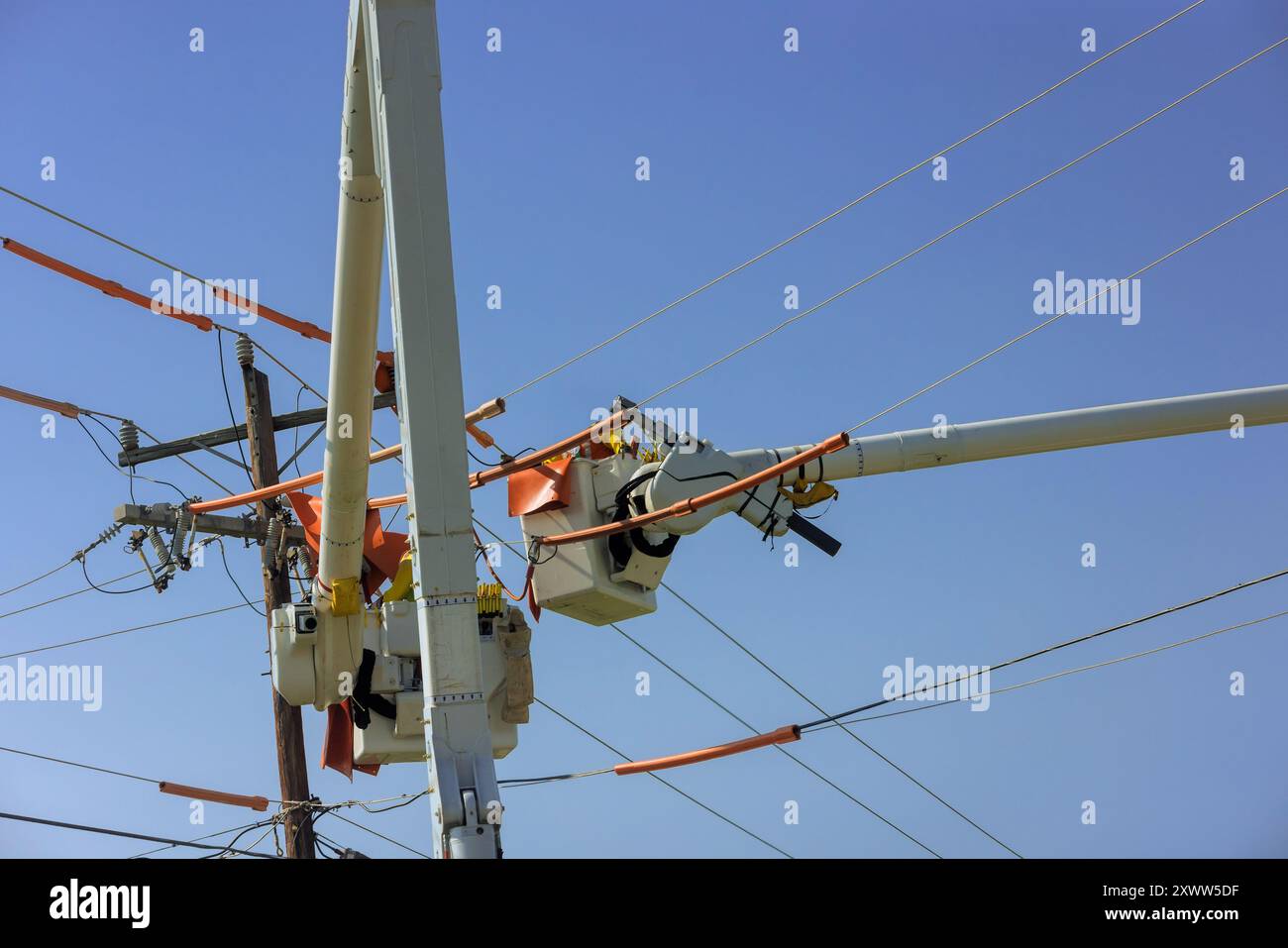In order to maintains service on power line, lineman uses insulated ...
