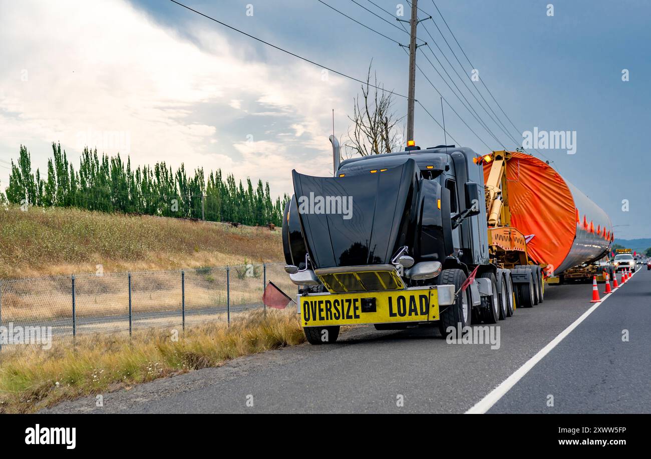 Industrial black broken big rig semi truck with open hood and oversize ...