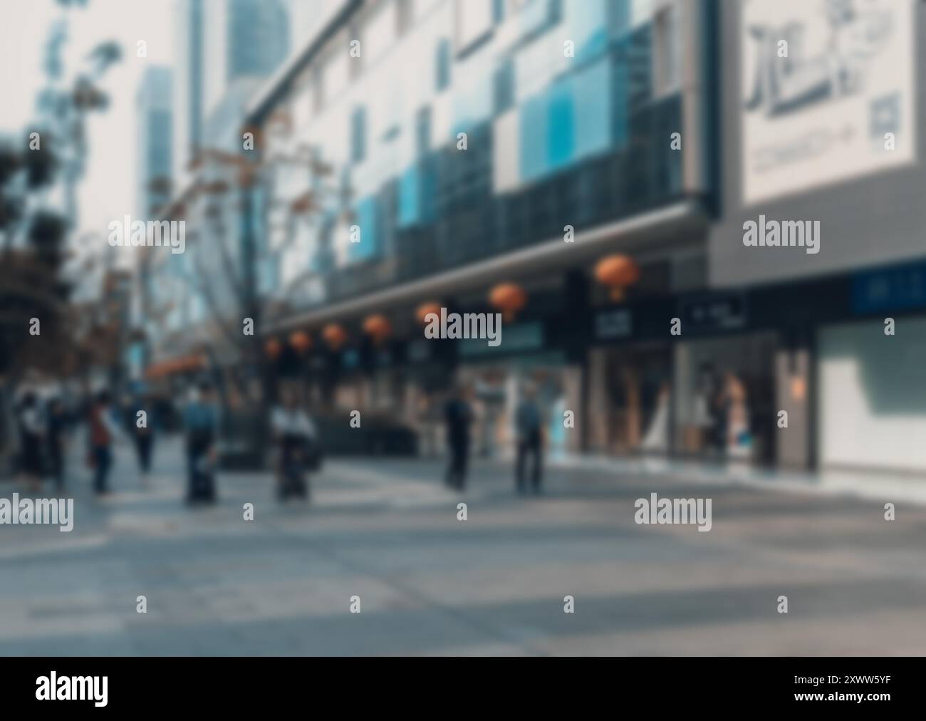 A blurred, urban scene in Shenzhen, China. The street is crowded with ...
