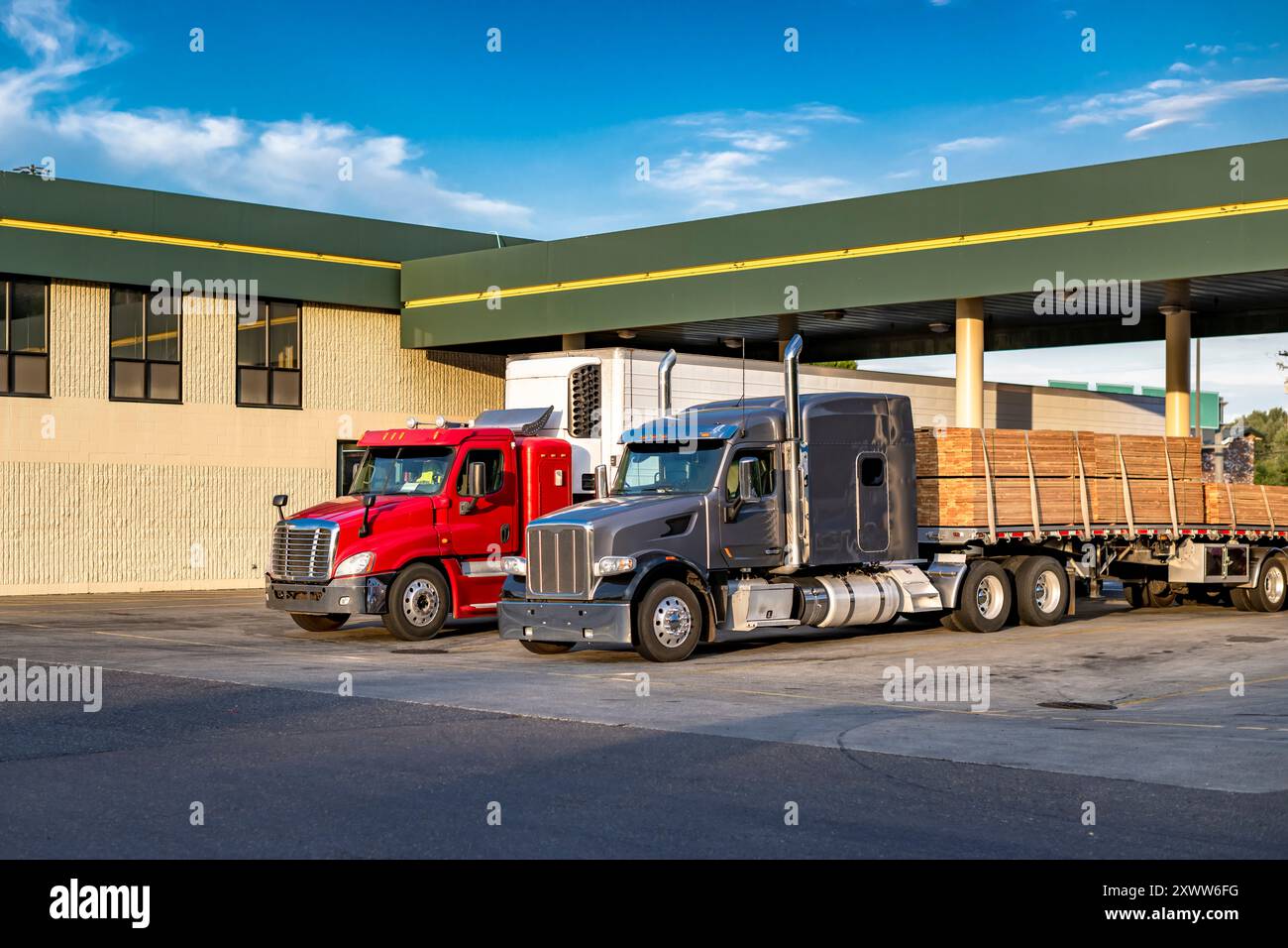 Industrial long haul big rig semi trucks with loaded refrigerator and ...