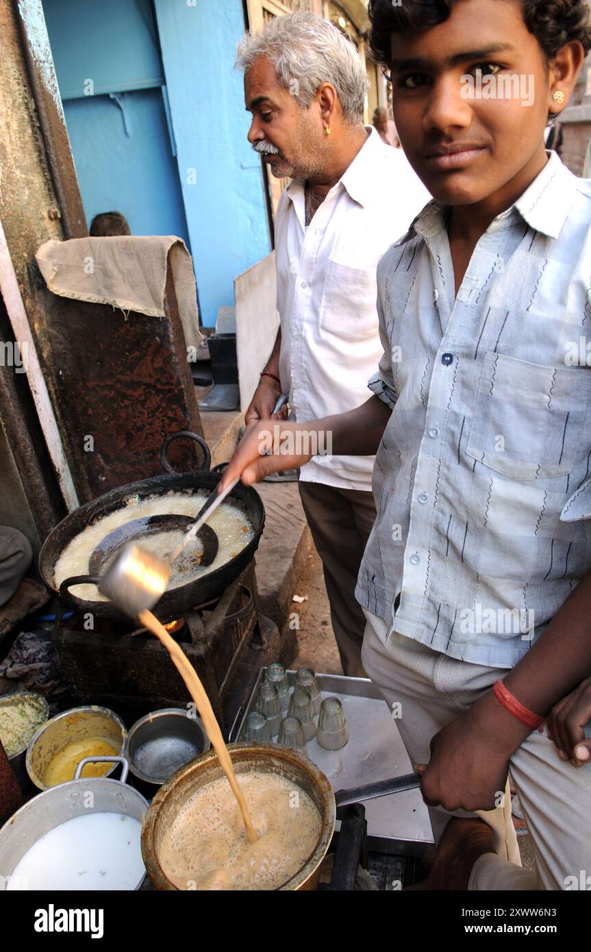 Indian Tea- Chai is cooked by a small tea vendor in the market of ...