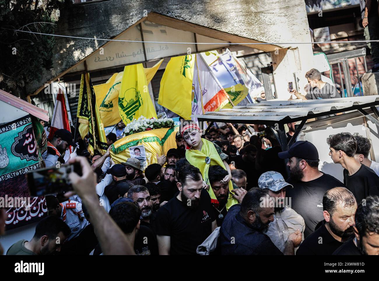 Mourners carry the coffin of Hezbollah fighter Abbas Badii Milhim, born ...