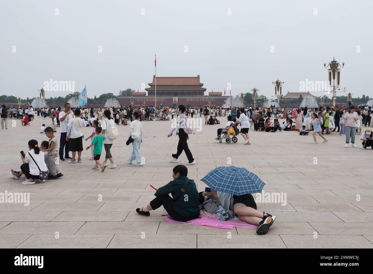 Beijing, China - August 17, 2024: Tourists resting in Tiananmen Square ...