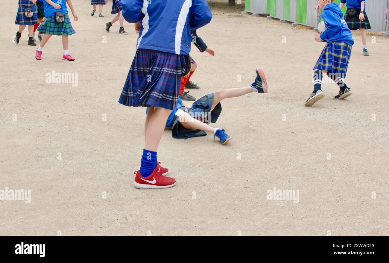 Boys with kilts playing rough Stock Photo - Alamy
