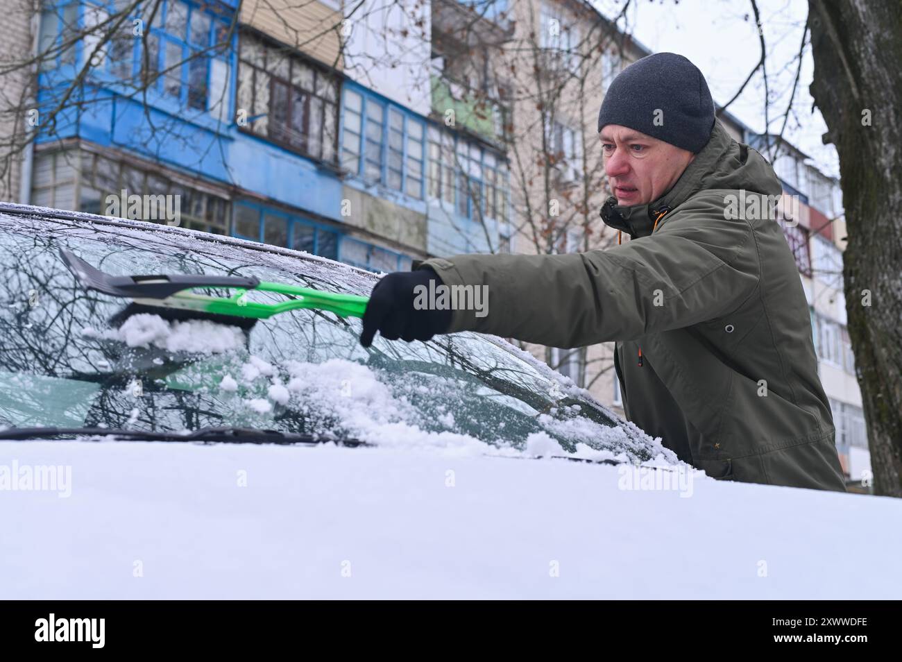 Driver removing snow ice from hi-res stock photography and images - Alamy