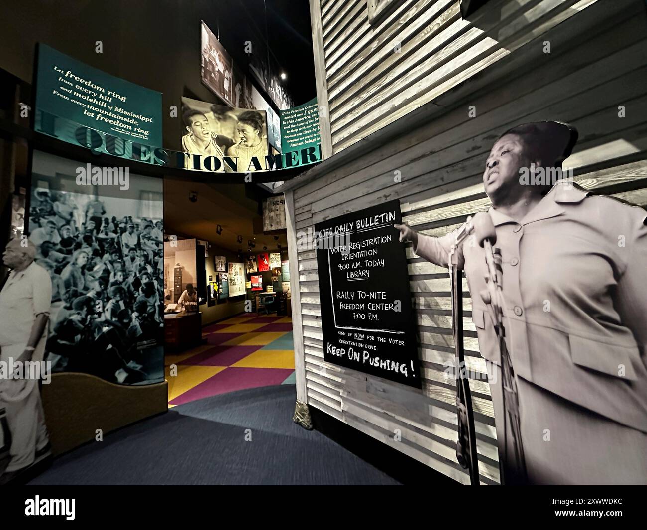 A life-size standee of Fannie Lou Hamer points to the "I Question ...