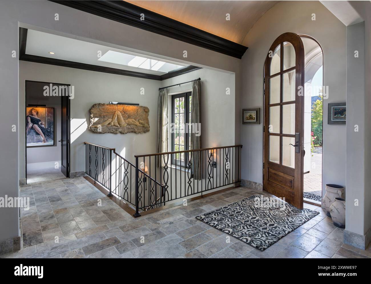 Entrance to high end house with tall round-top door and coved ceiling ...