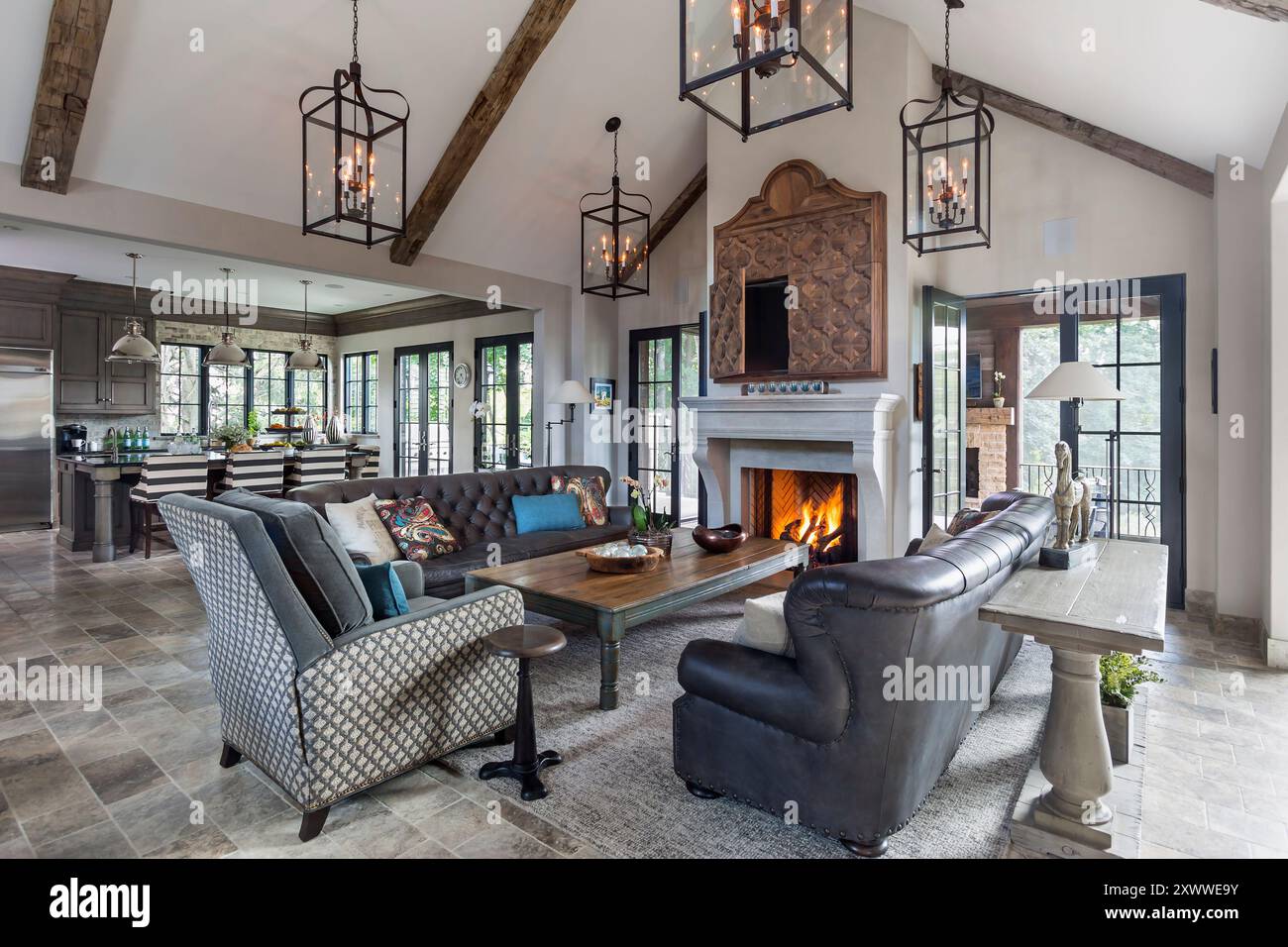 Living room with beamed cathedral ceiling and large stone fireplace ...