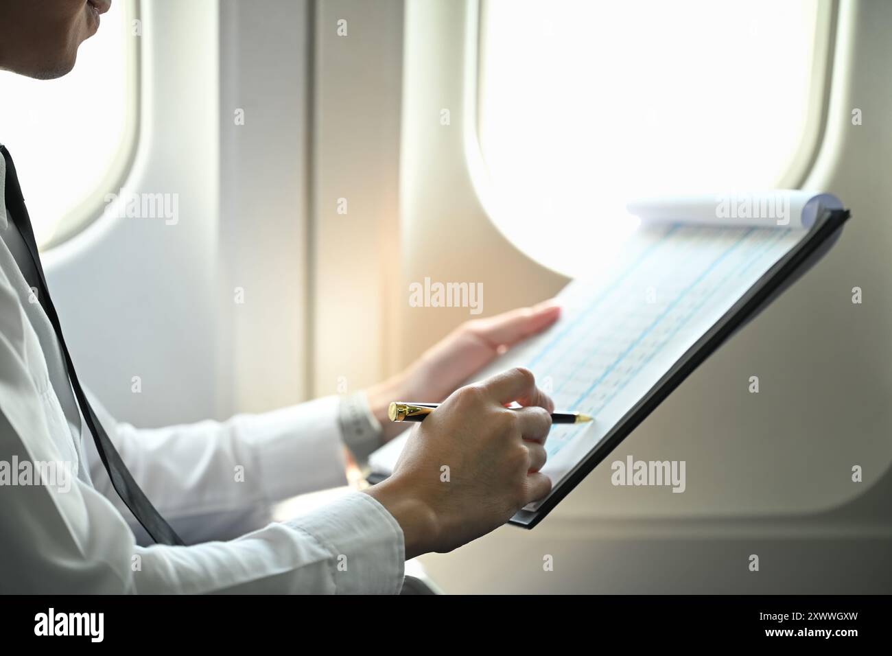 Close up image of pilot reviewing flight plans or other important ...
