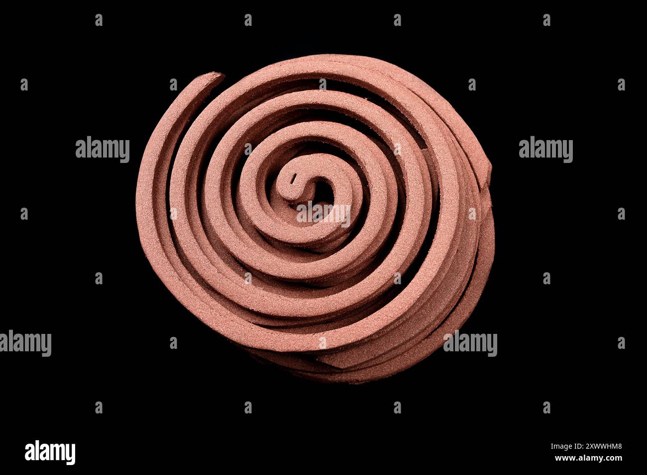 Mosquito coils on black background. The spiral is very large and has a ...