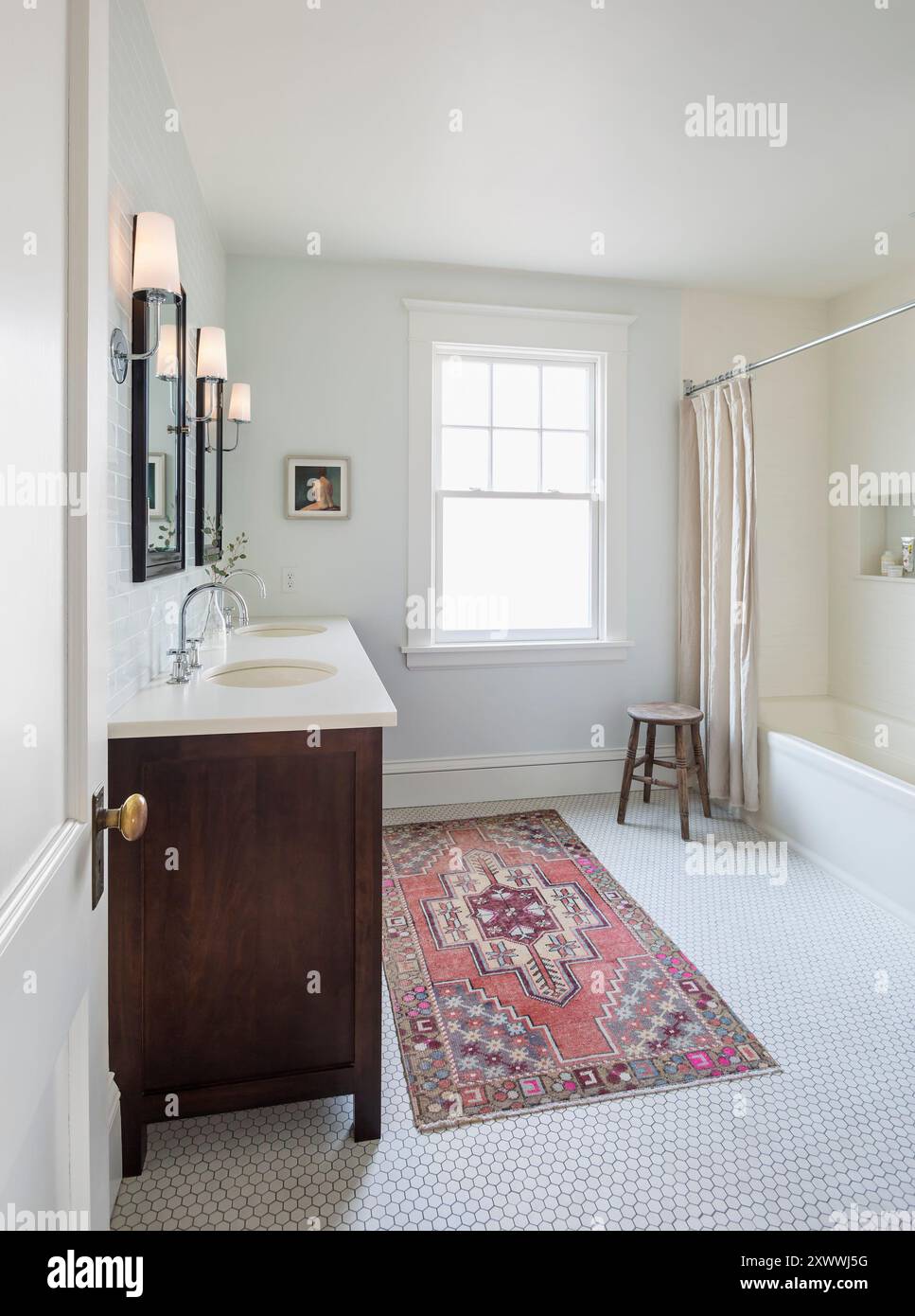 Bathroom with dark wood double vanity and vintage rug Stock Photo - Alamy