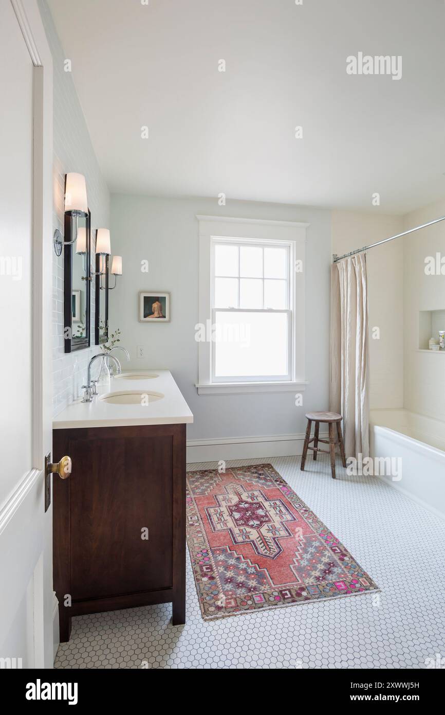 Bathroom with dark wood double vanity and vintage rug Stock Photo - Alamy