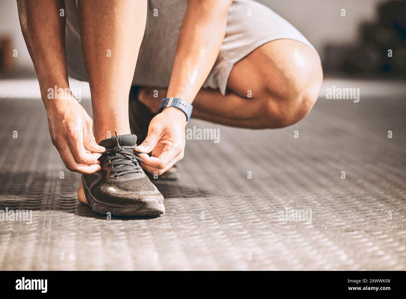 Hands, sneakers and person tie laces in gym with workout, fitness or ...