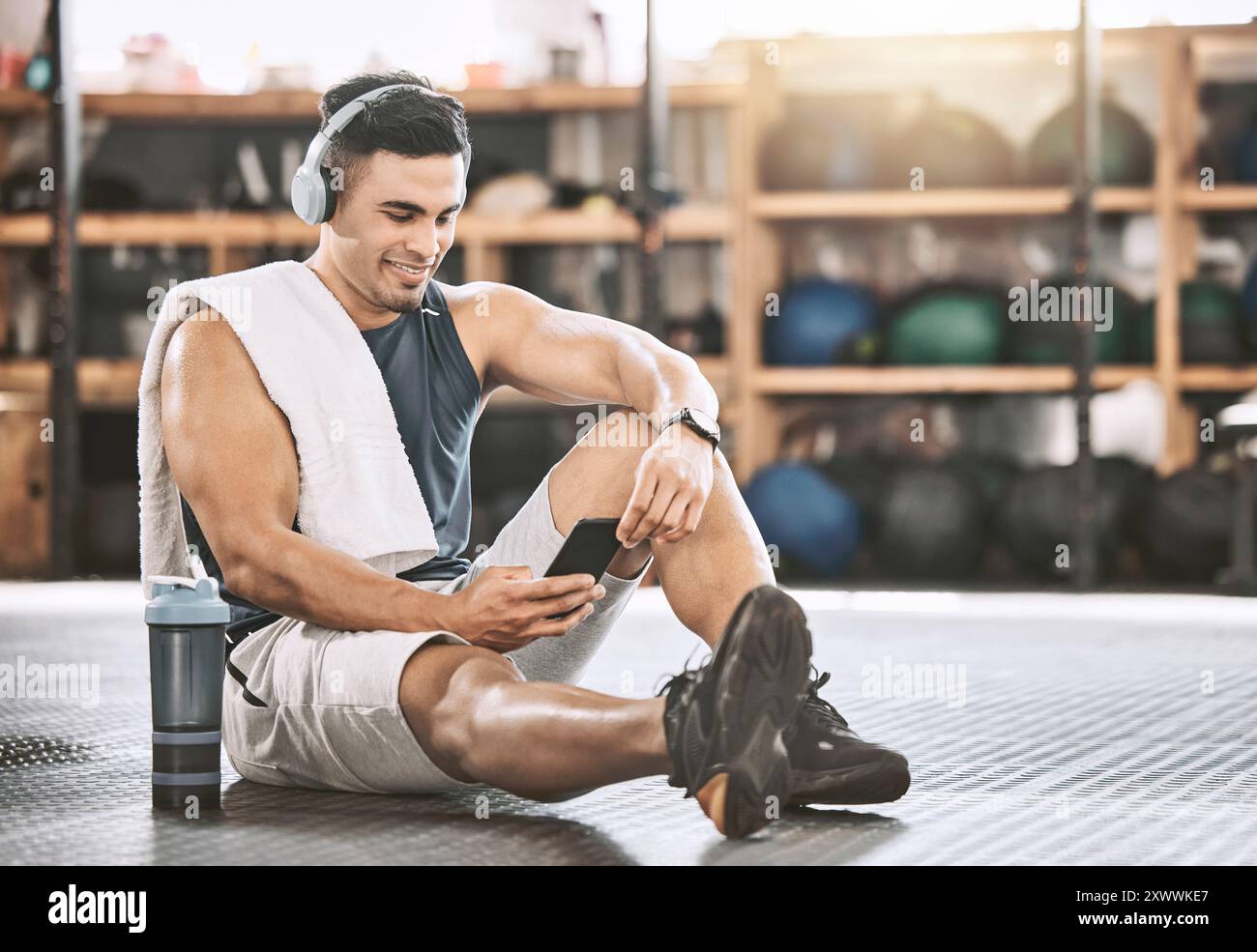Fitness, man and relax in gym with smartphone for music, exercise ...