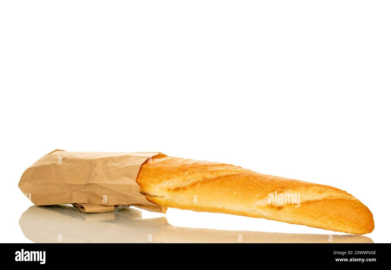 One aromatic baguette in a paper bag, macro, isolated on white ...