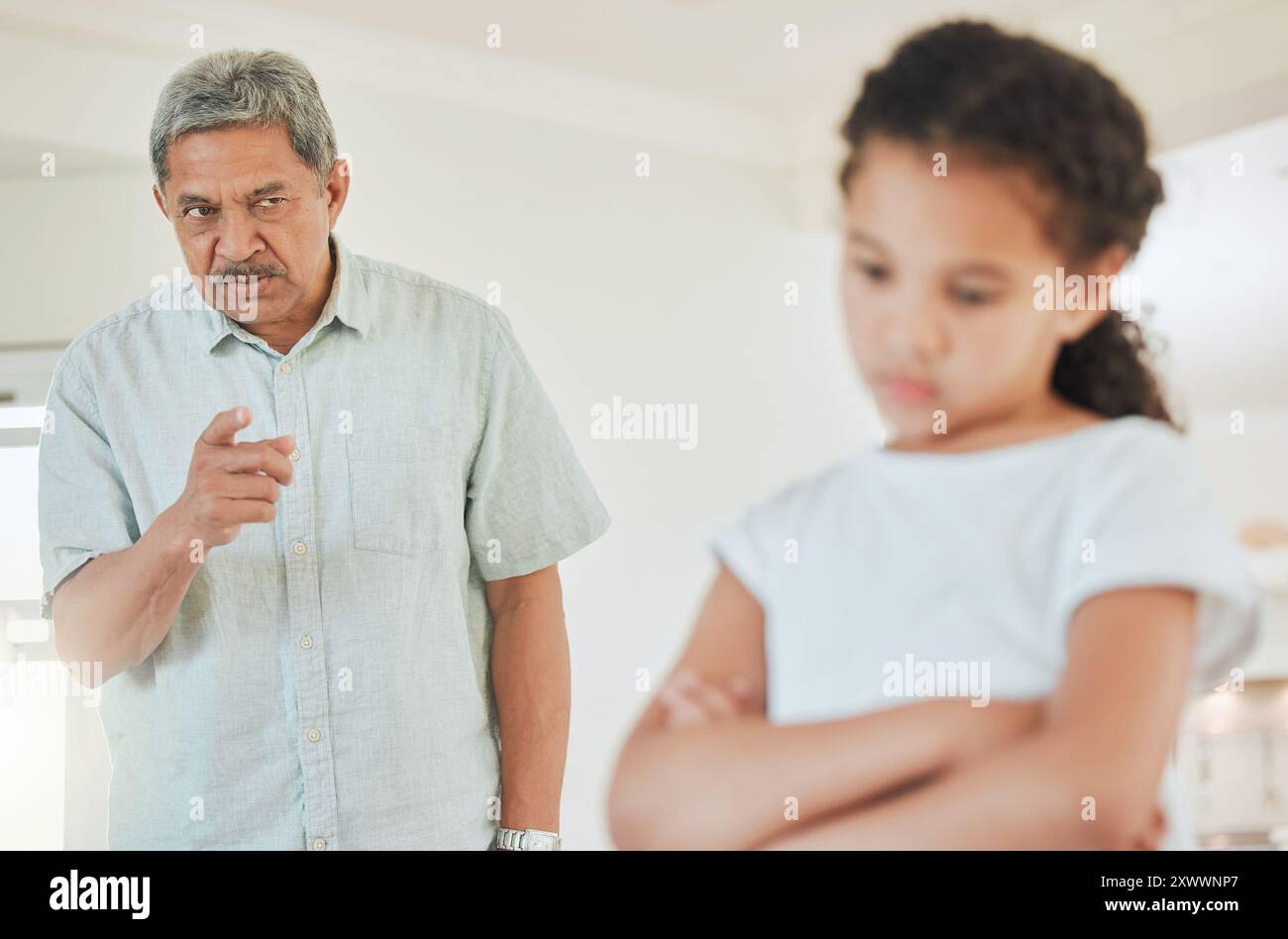 Senior man, irritated and girl in home with point, lesson and ...