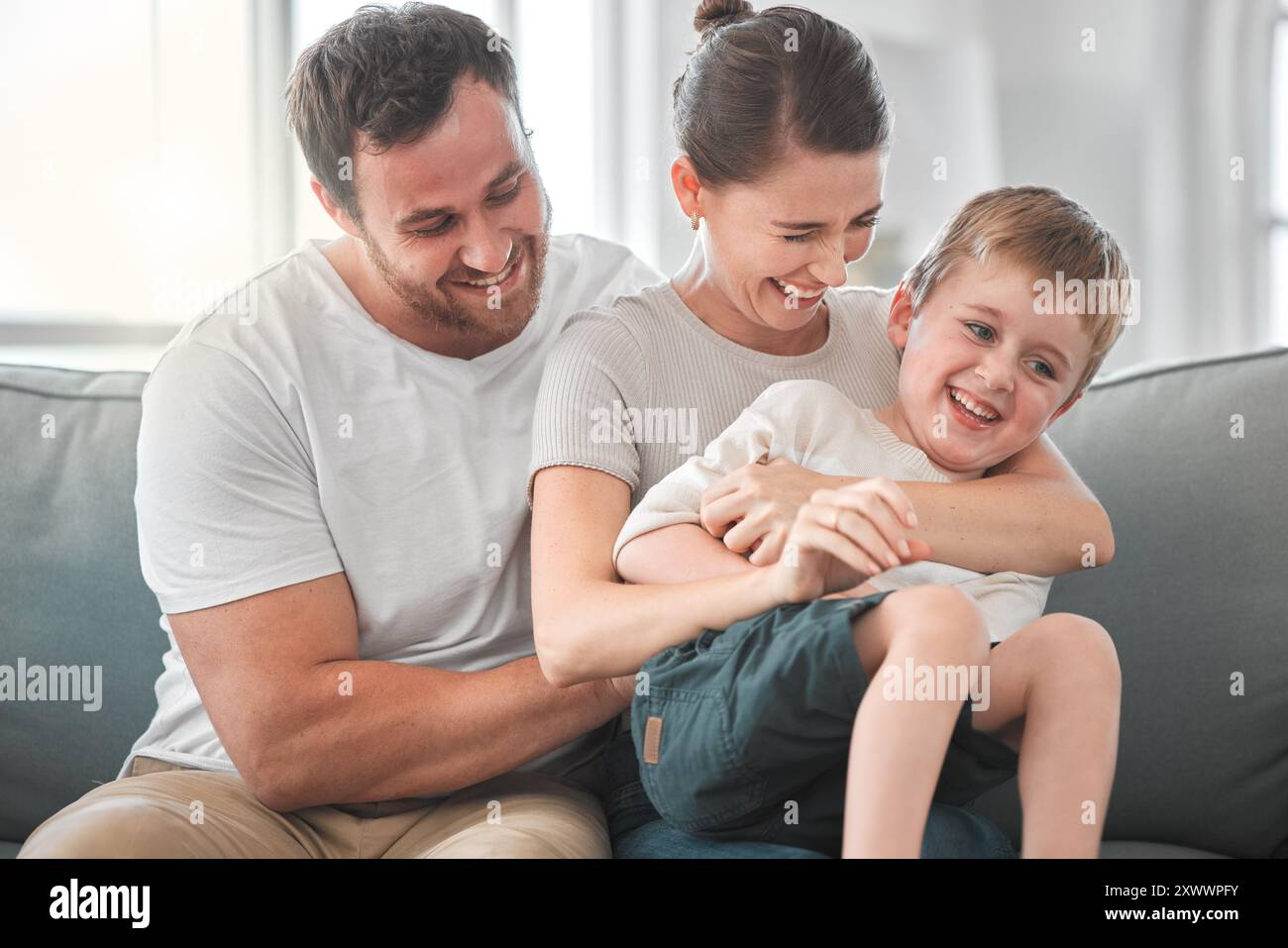 Couch, parents and boy with laugh for tickle, connection and bonding ...