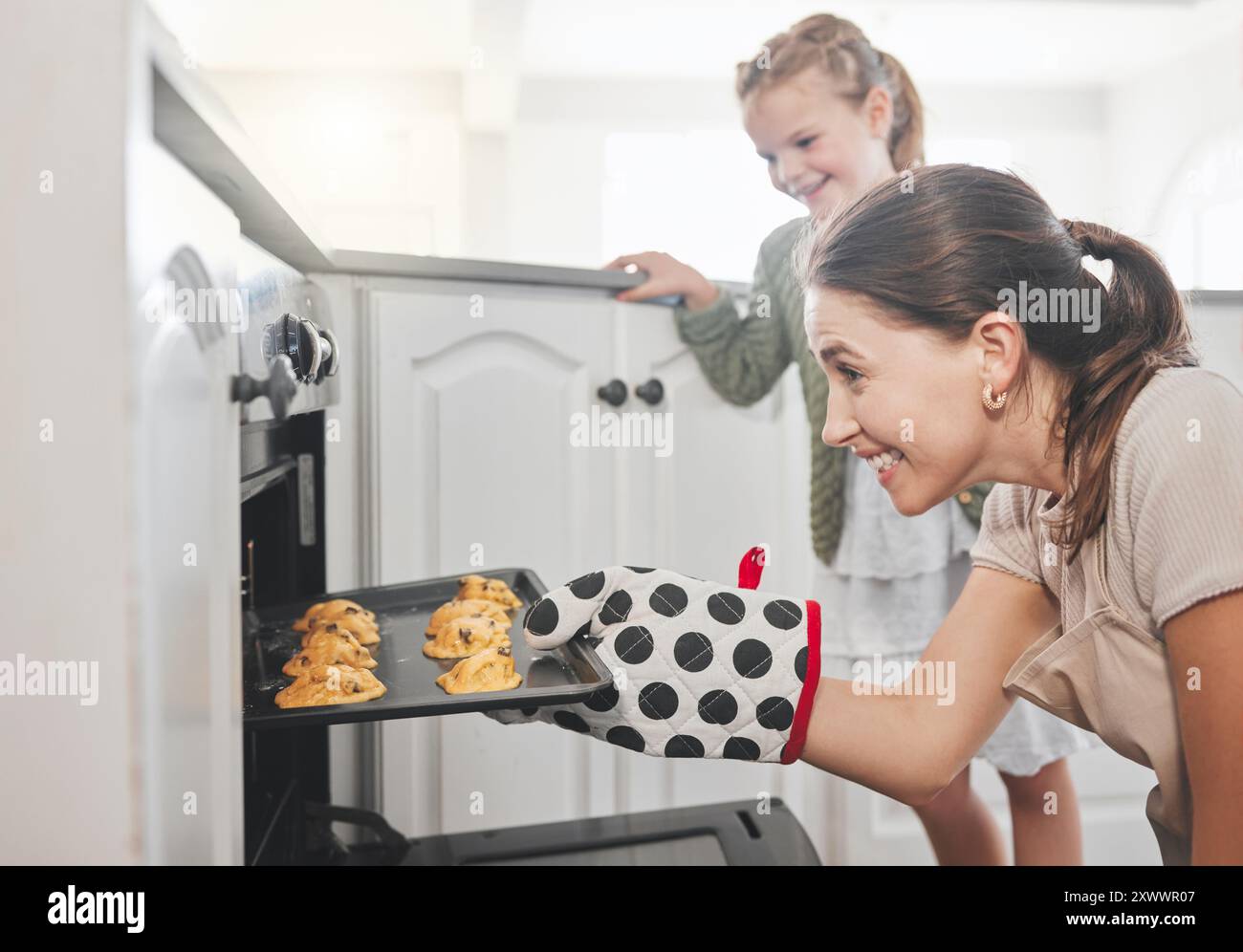 Mom, kid and cookies at oven for baking, bonding and learning in home ...