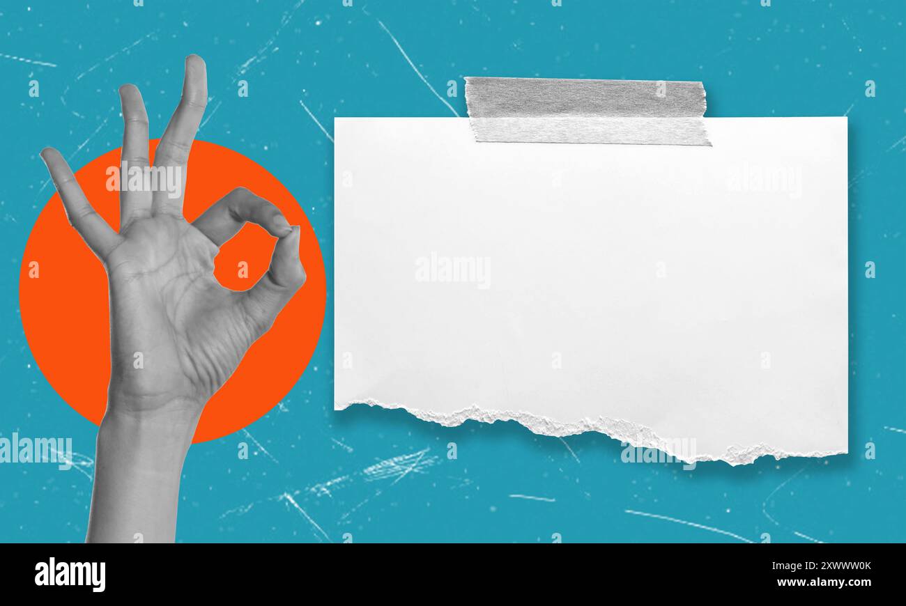 A hand displays an 'okay' sign next to a torn blank sheet of paper ...
