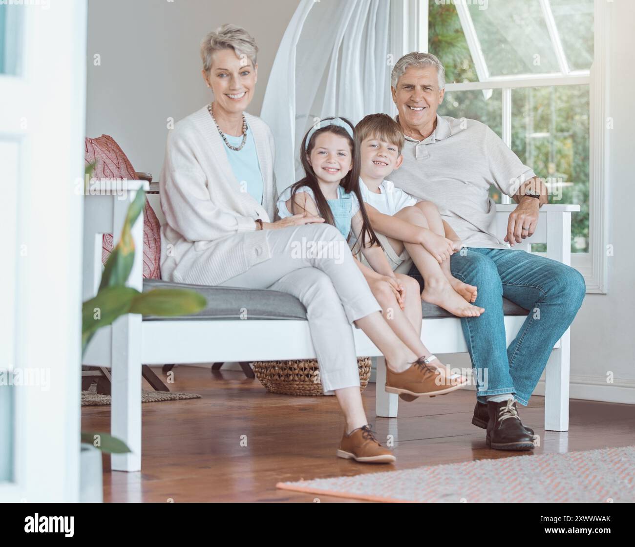 Grandparents, grandkids and portrait on sofa in home with embrace ...