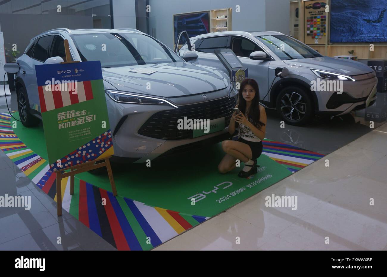HANGZHOU, CHINA - AUGUST 21, 2024 - Customers learn about BYD's electric cars at a BYD sales ...