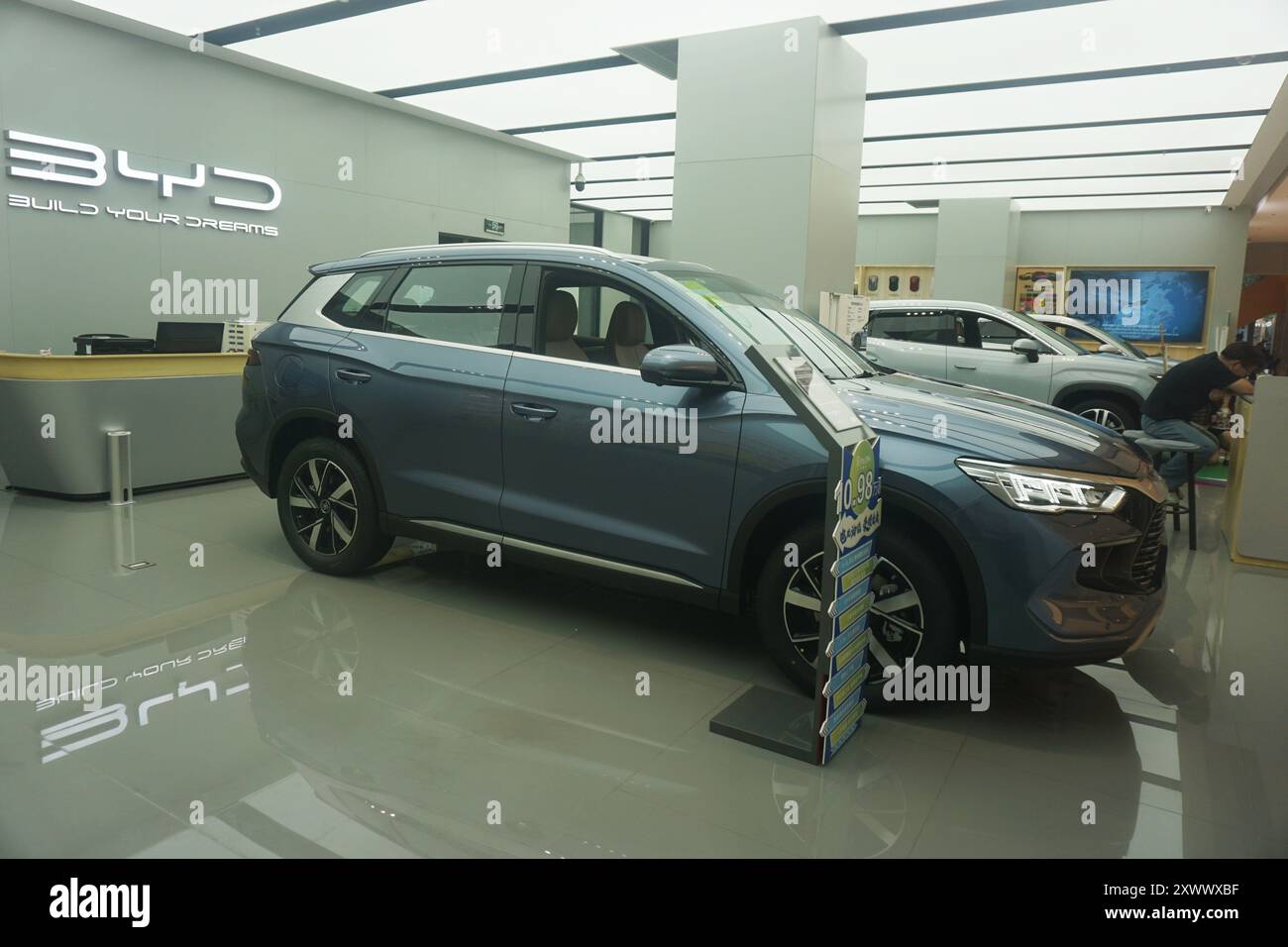 HANGZHOU, CHINA - AUGUST 21, 2024 - Customers learn about BYD's electric cars at a BYD sales ...