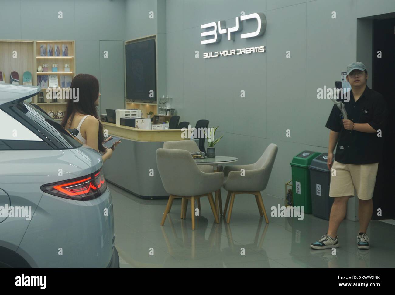 HANGZHOU, CHINA - AUGUST 21, 2024 - Customers learn about BYD's electric cars at a BYD sales ...