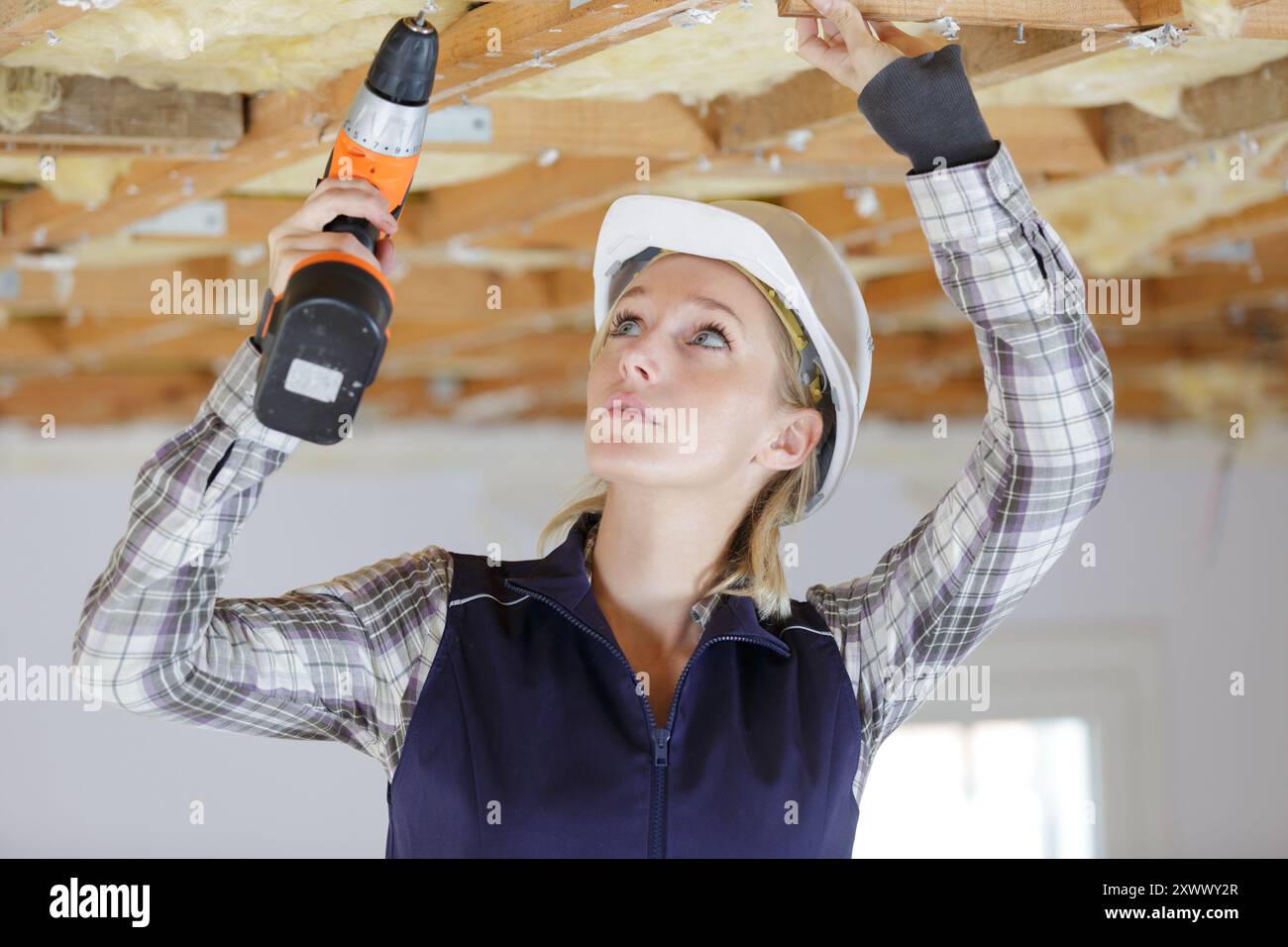 Worker using drill assemble hi-res stock photography and images - Alamy