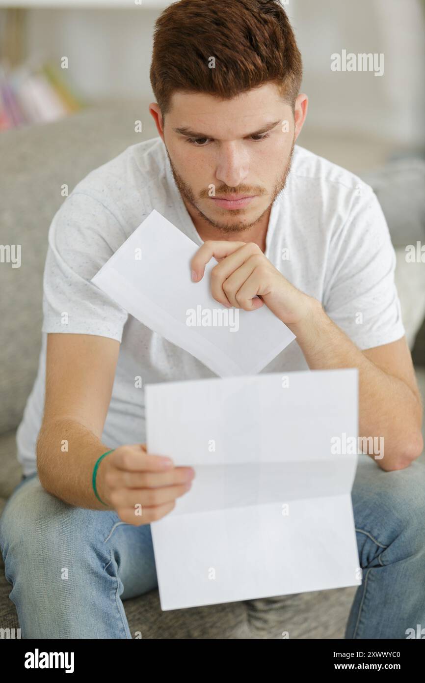 a young man reading letter Stock Photo - Alamy