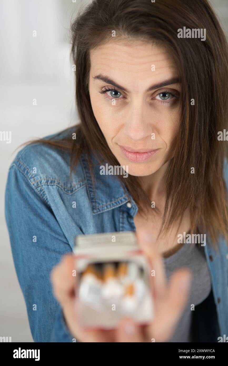 a woman offering a cigarette Stock Photo - Alamy