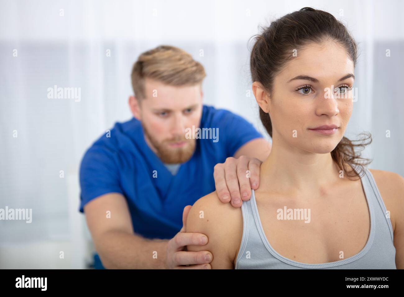a modern rehabilitation physiotherapy man at work with woman Stock ...