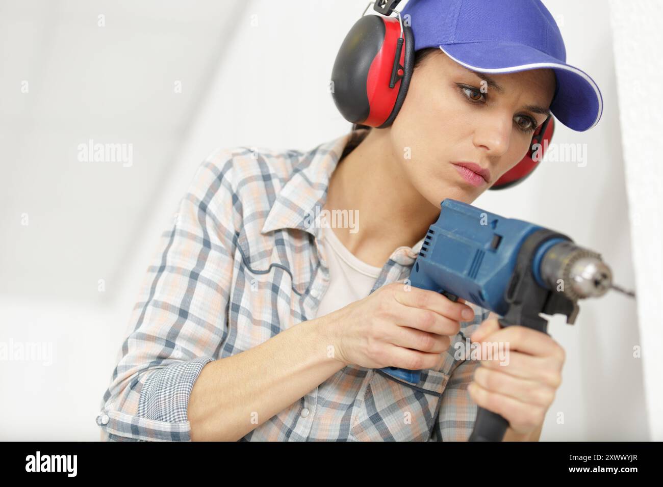 Construction worker is holding a cordless drill hi-res stock ...
