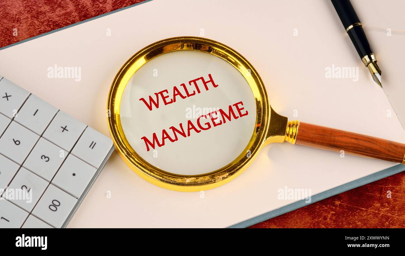 WEALTH MANAGEMENT words written through a magnifying glass in red ...