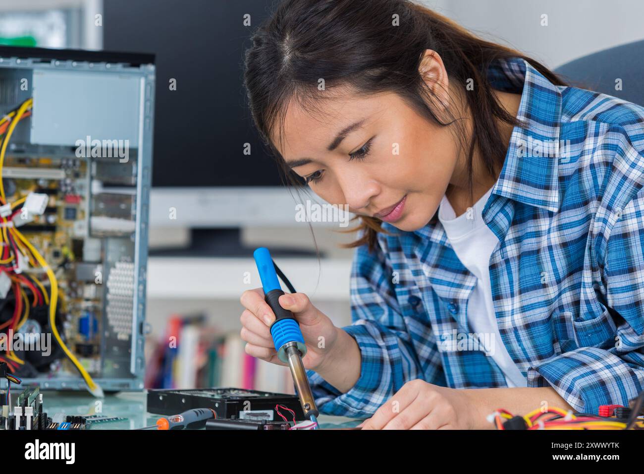 female computer technician using soldering iron Stock Photo - Alamy