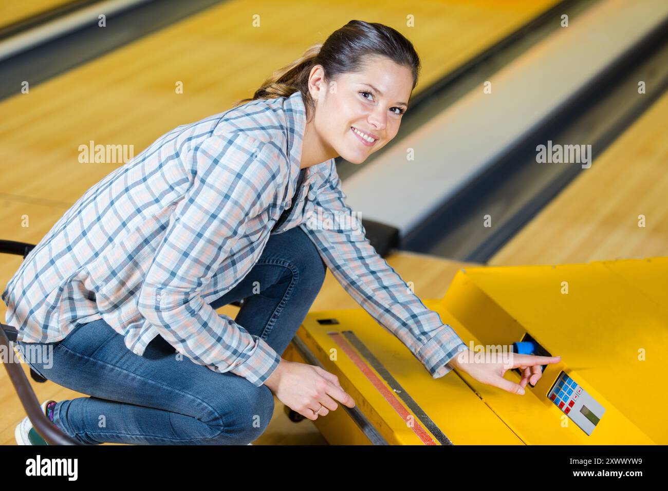 woman using bowling ball machine Stock Photo - Alamy