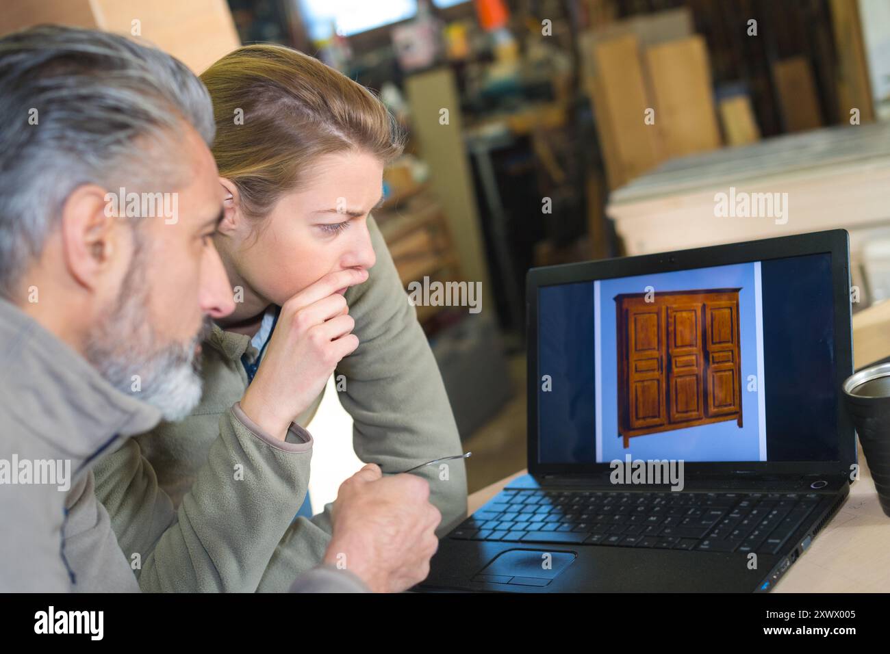 cabinet manufacturers looking at a design Stock Photo - Alamy